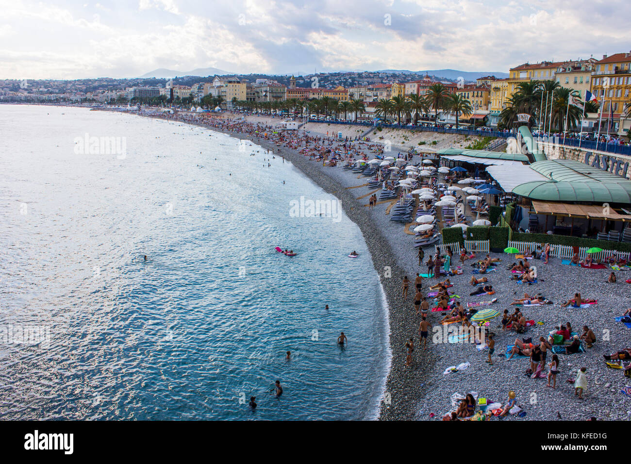 People enjoy a beautiful summer sunset in the Opera Plage, the oldes ...