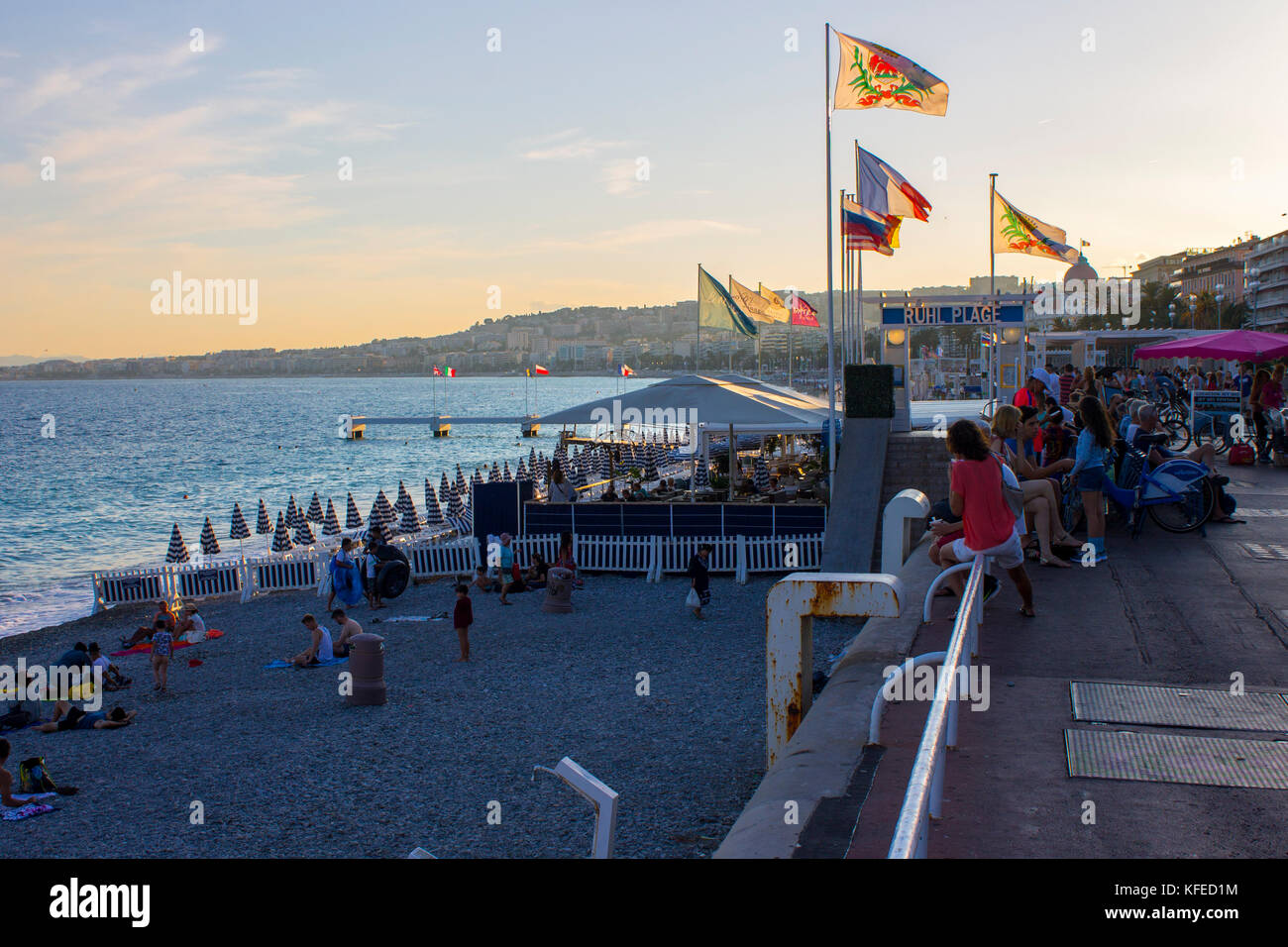 People enjoy a beautiful summer sunset in the Opera Plage, the oldes ...