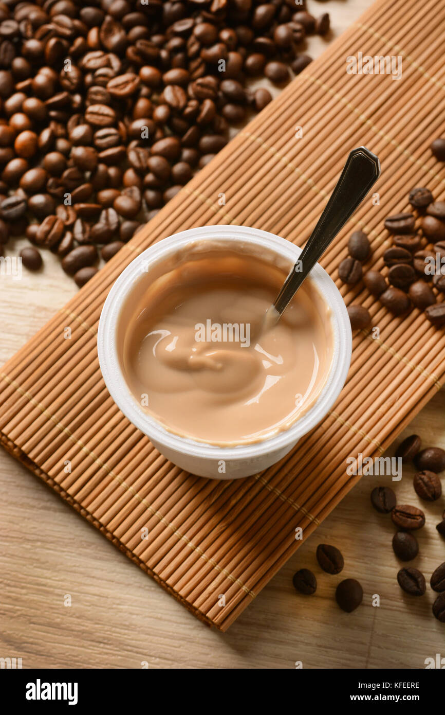 Coffee-flavored yogurt with coffee beans around - closeup Stock Photo ...
