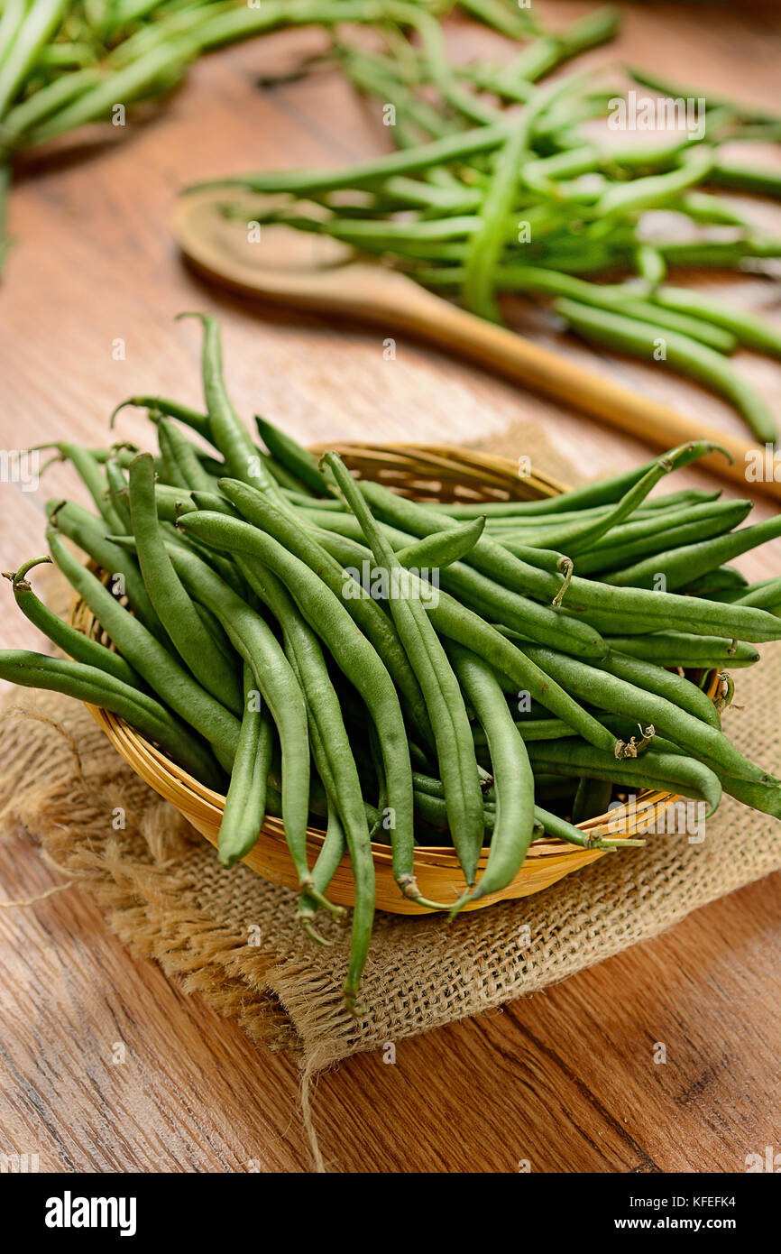 Pile of green beans on wooden table - closeup Stock Photo - Alamy