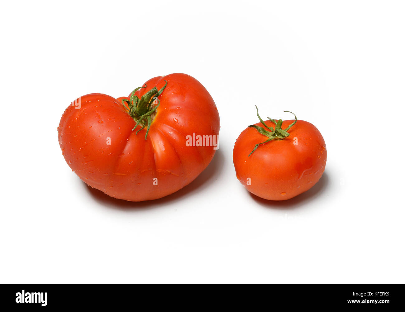 Two red tomatoes on white background - closeup Stock Photo - Alamy