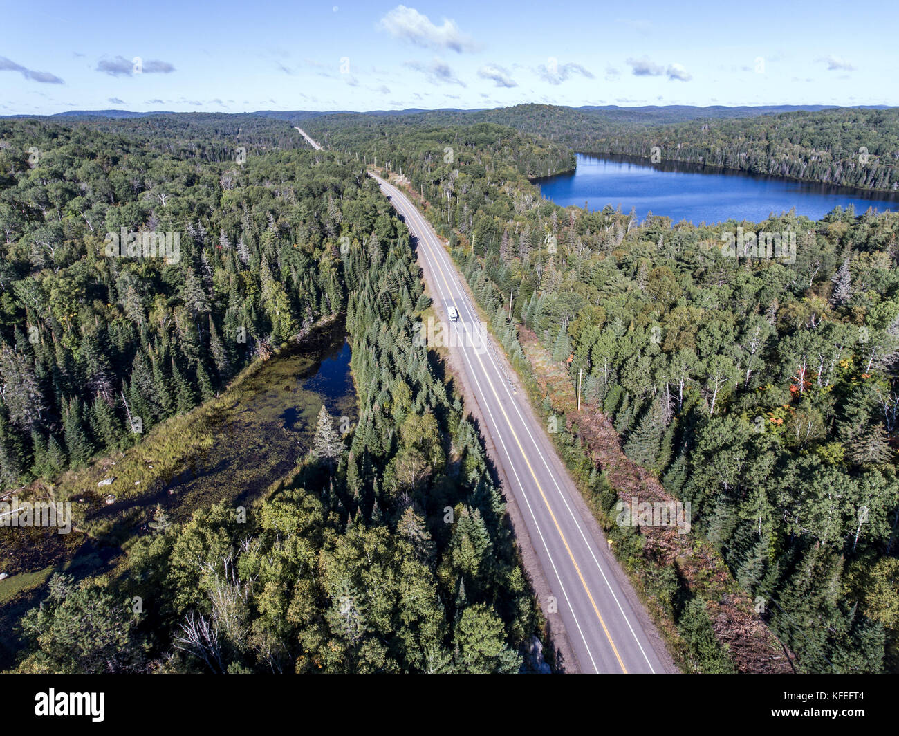 Canada beautiful scenic camper bus driving on road in the endless pine ...