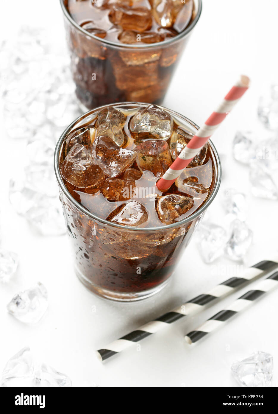 Cola with crushed ice in the glass on white background - closeup Stock ...
