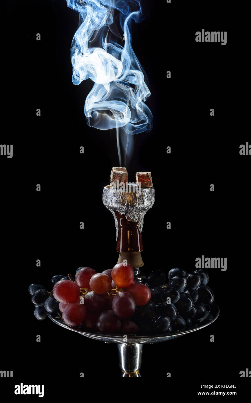 Smoking hookah with fruit head on dark background Stock Photo - Alamy