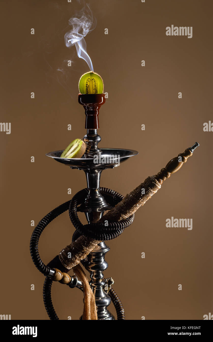 Smoking hookah with fruit head on dark background Stock Photo - Alamy