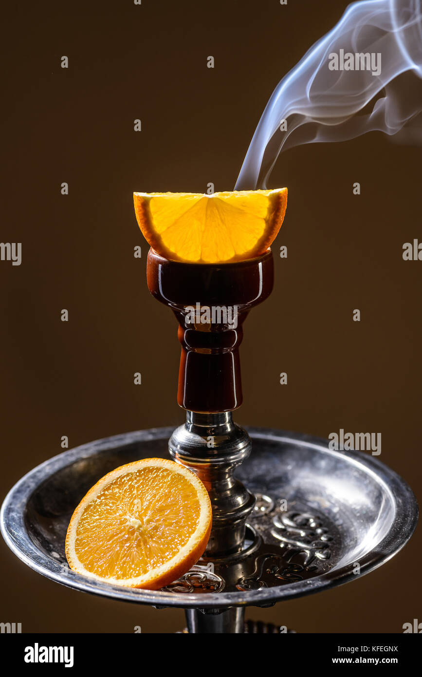 Smoking hookah with fruit head on dark background Stock Photo - Alamy