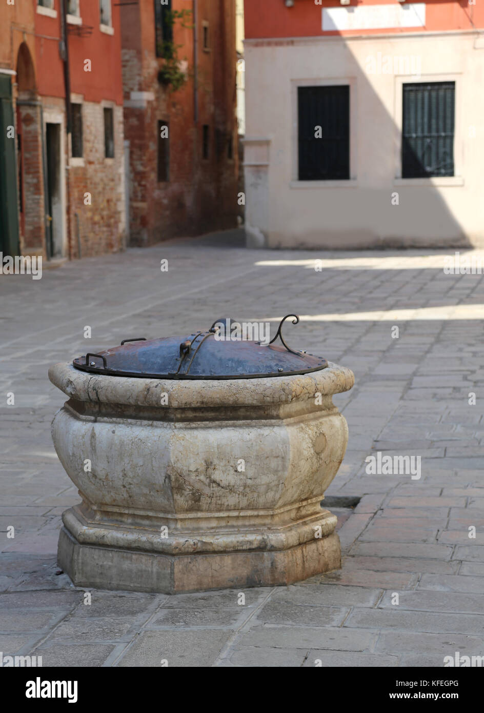 very ancient stone well in a square of VENICE in Italy Stock Photo - Alamy