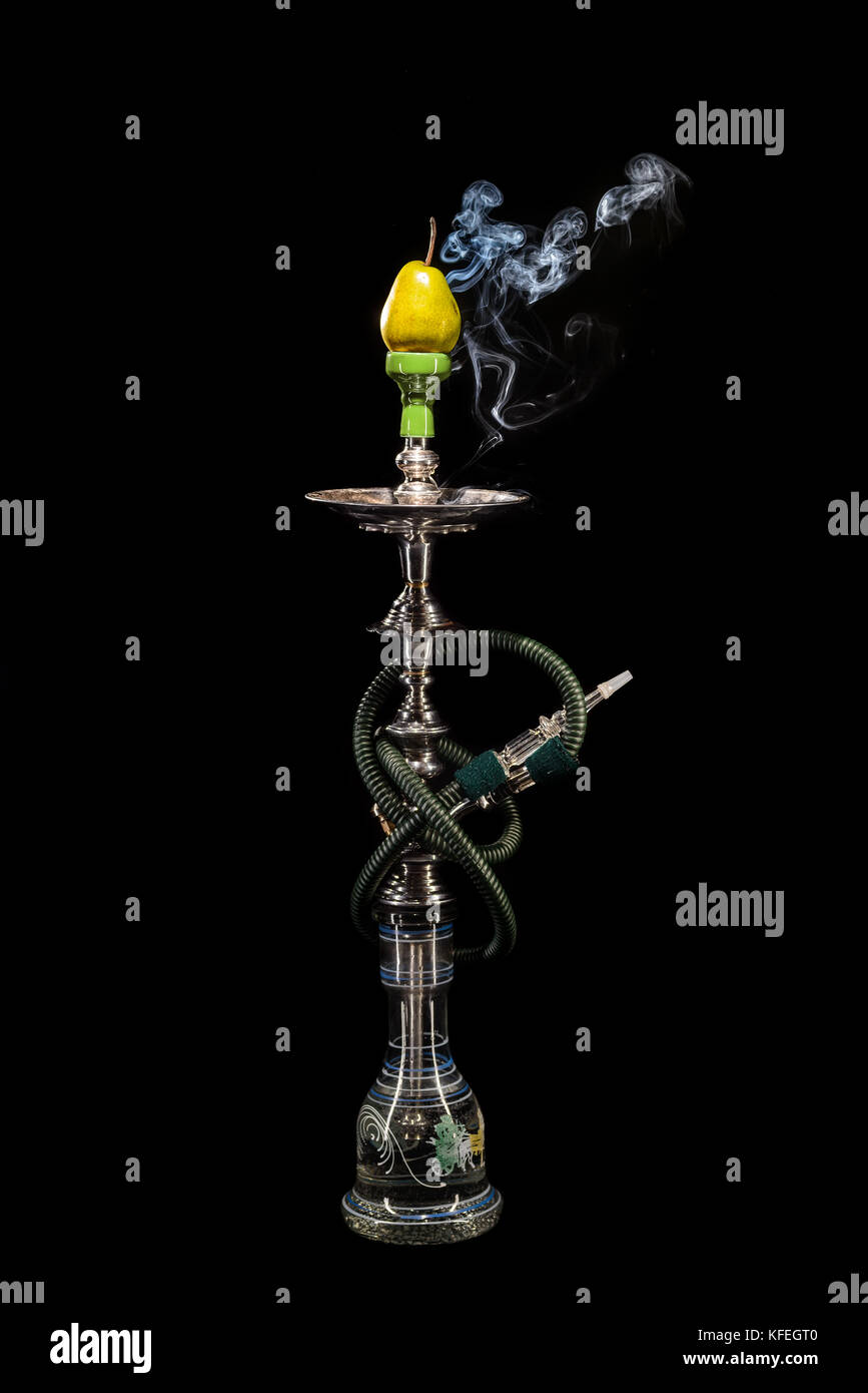 Smoking hookah with fruit head on dark background Stock Photo - Alamy