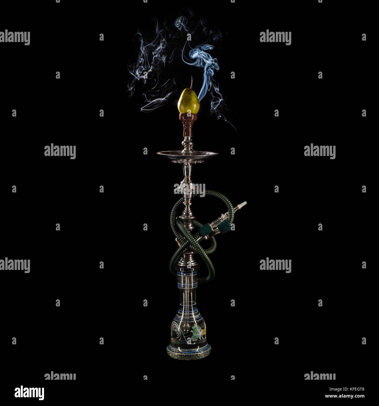 Smoking hookah with fruit head on dark background Stock Photo - Alamy
