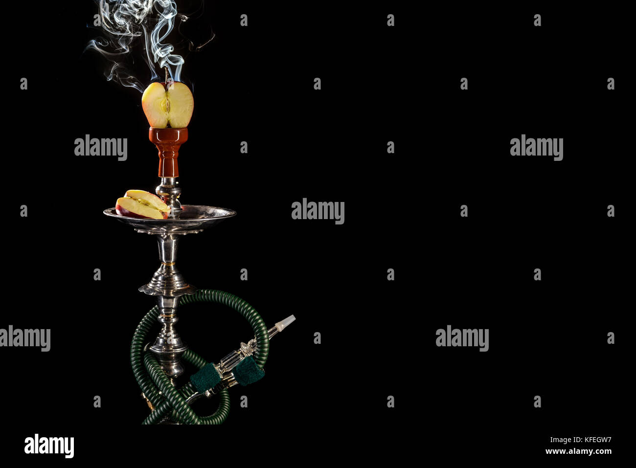 Smoking hookah with fruit head on dark background Stock Photo - Alamy