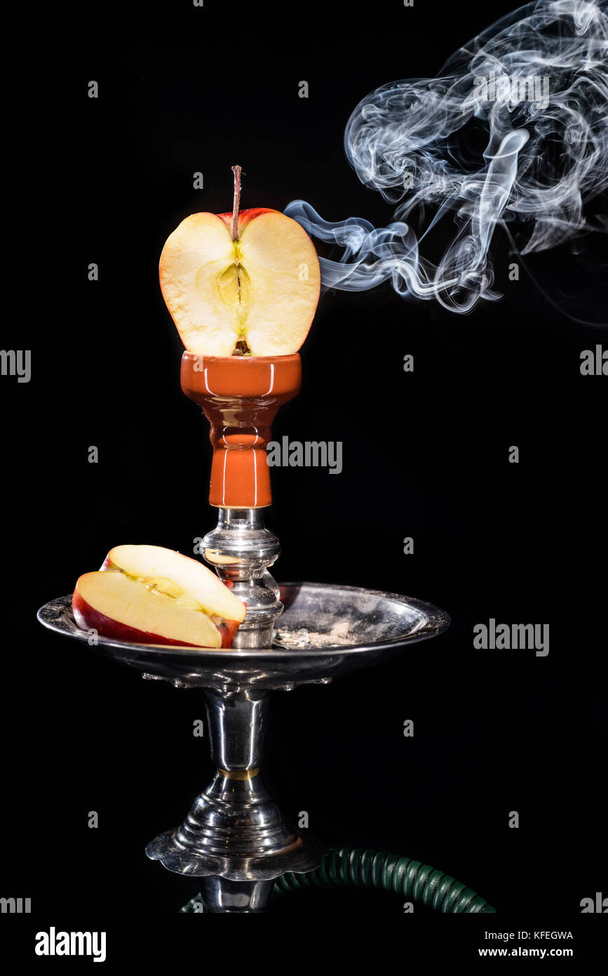 Smoking hookah with fruit head on dark background Stock Photo - Alamy