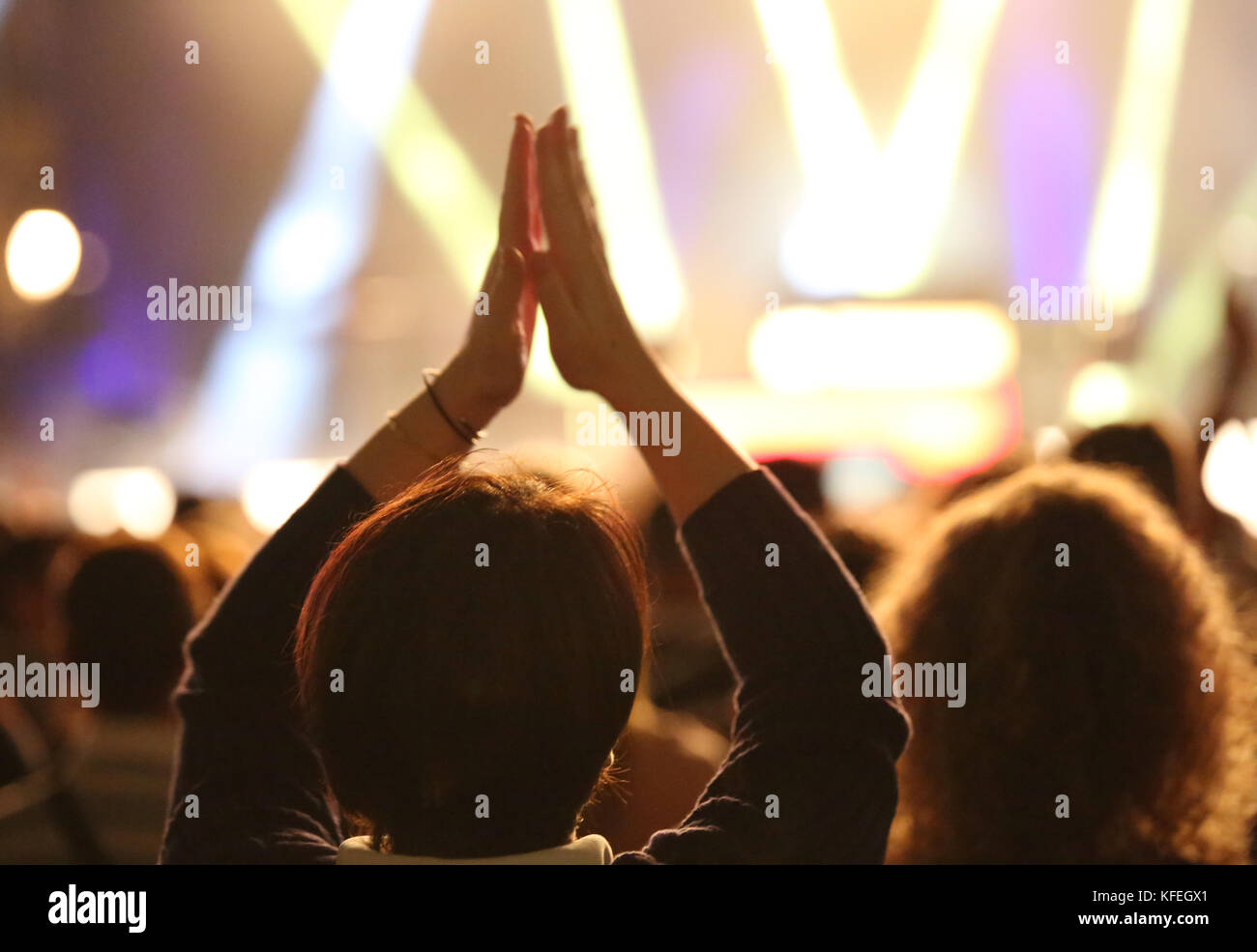 fans while applauding the rock band during the live concert Stock Photo ...