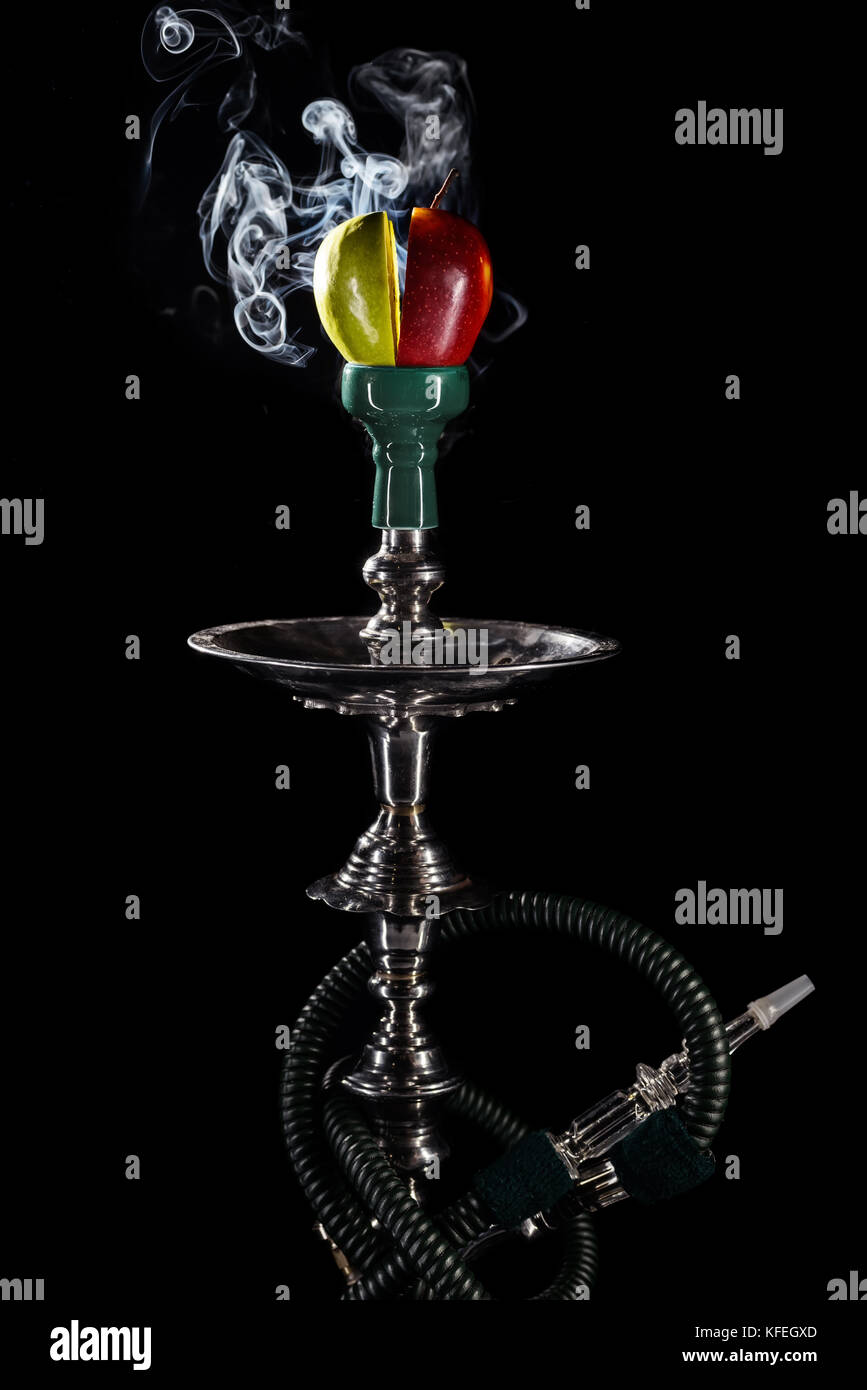 Smoking hookah with fruit head on dark background Stock Photo - Alamy