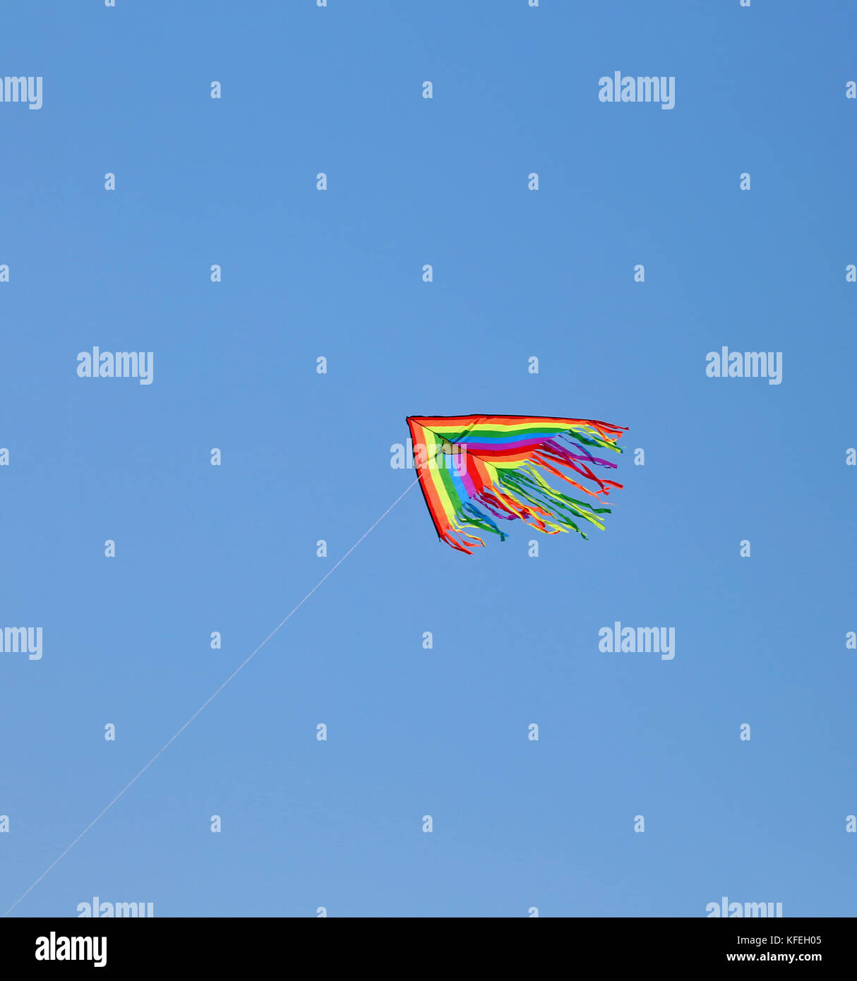 huge kite flying high in blue sky in summer Stock Photo - Alamy