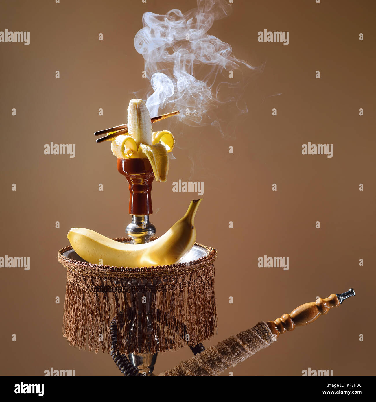 Smoking hookah with fruit head on dark background Stock Photo - Alamy