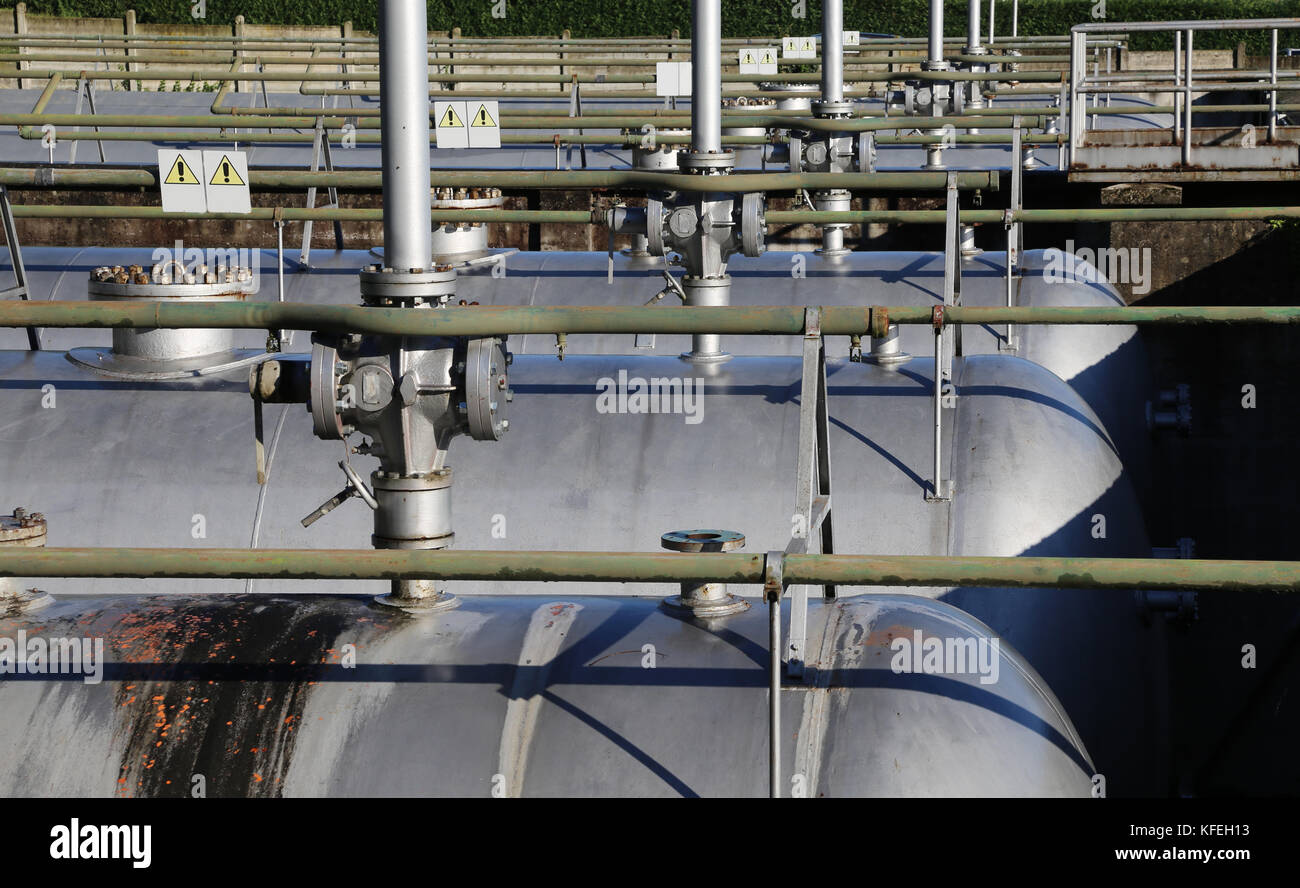 series of big metal tanks for gas storage inside an industrial area ...