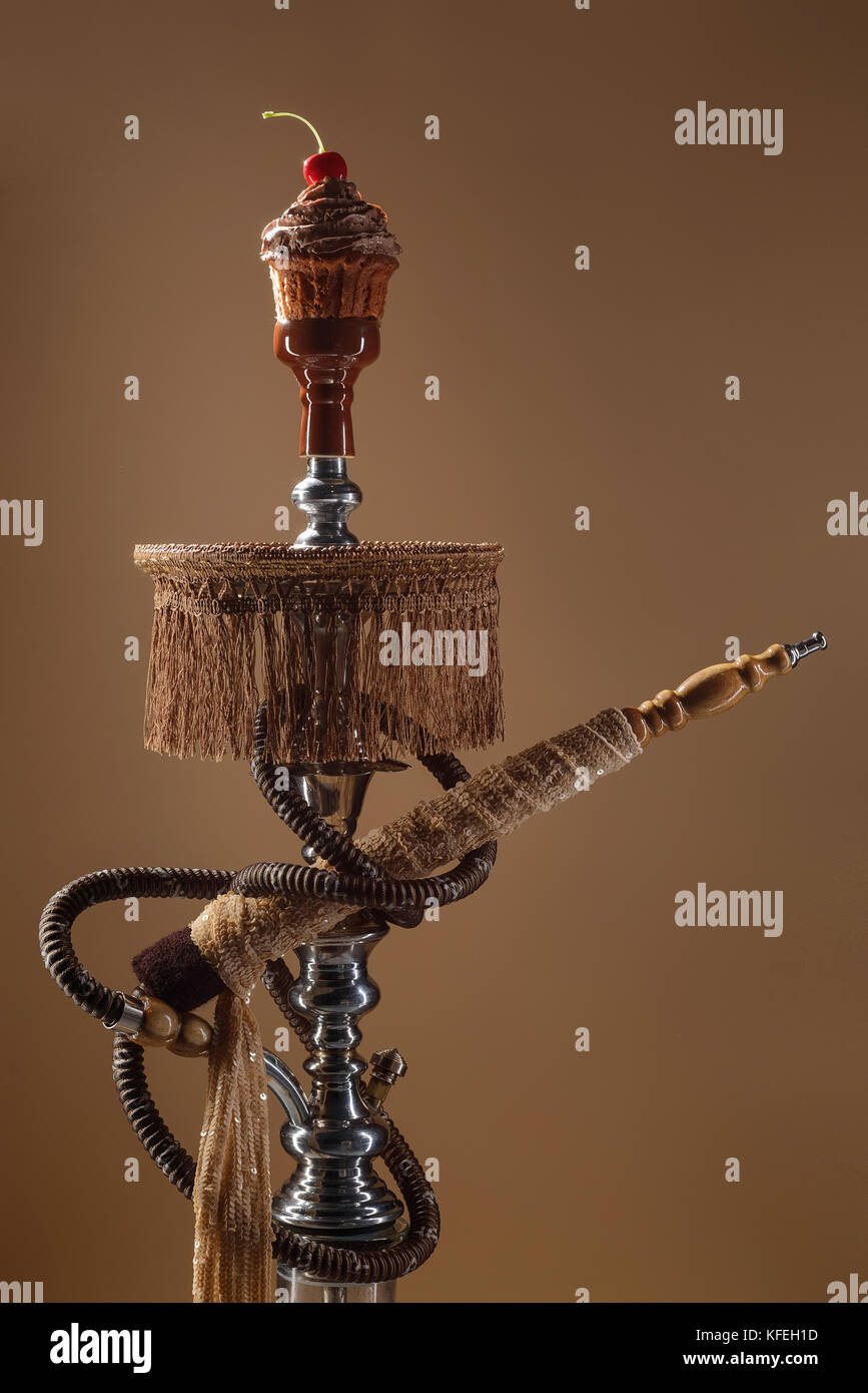 Smoking hookah with fruit head on dark background Stock Photo - Alamy