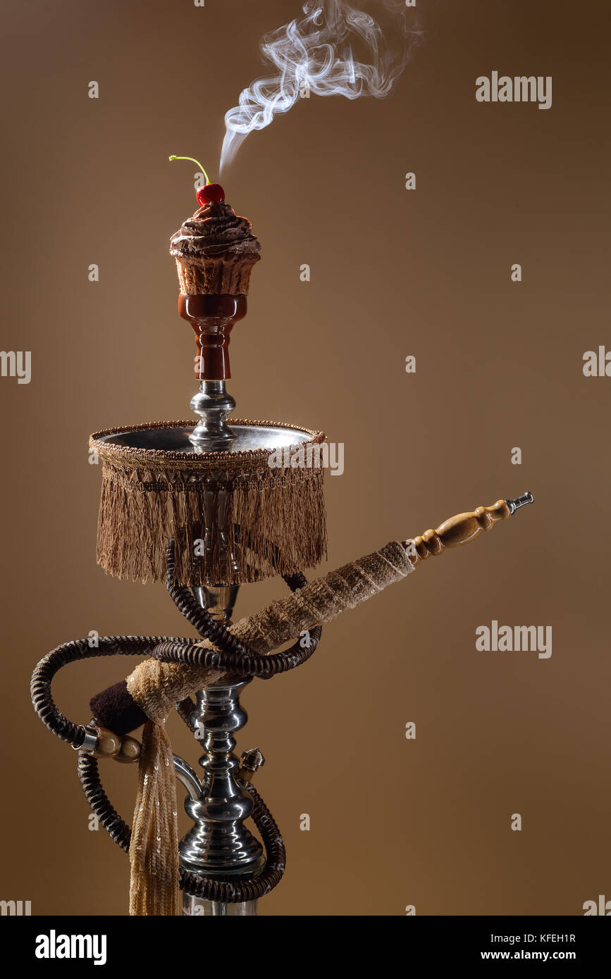 Smoking hookah with fruit head on dark background Stock Photo - Alamy