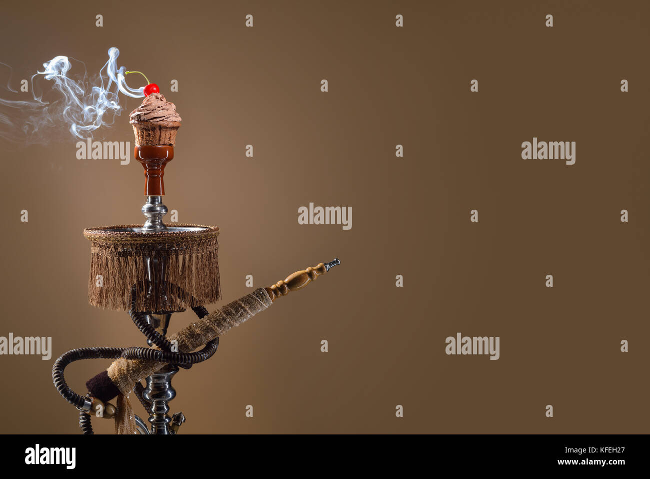 Smoking hookah with fruit head on dark background Stock Photo - Alamy