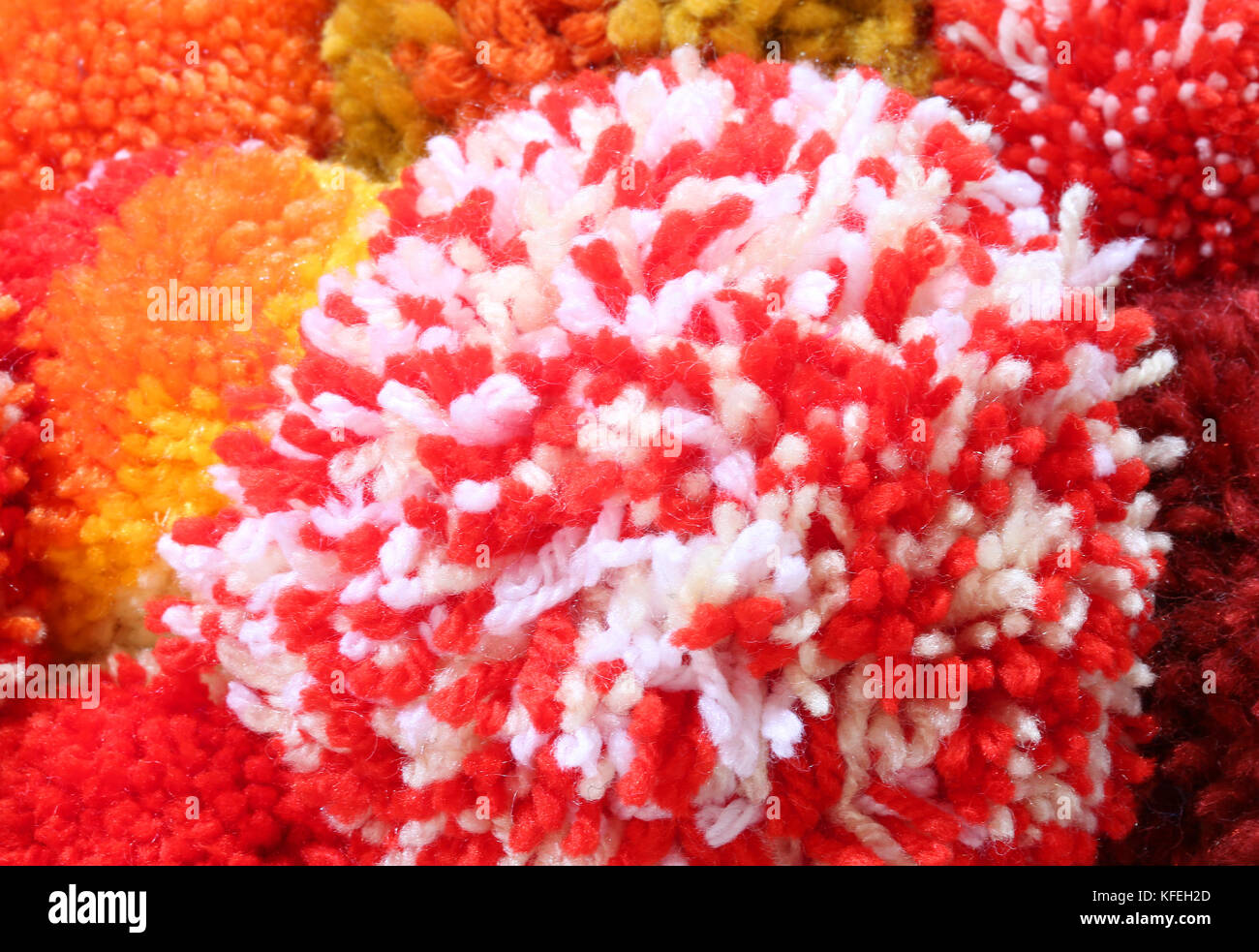 soft pompom or also called pon-pon background made with woolen threads ...