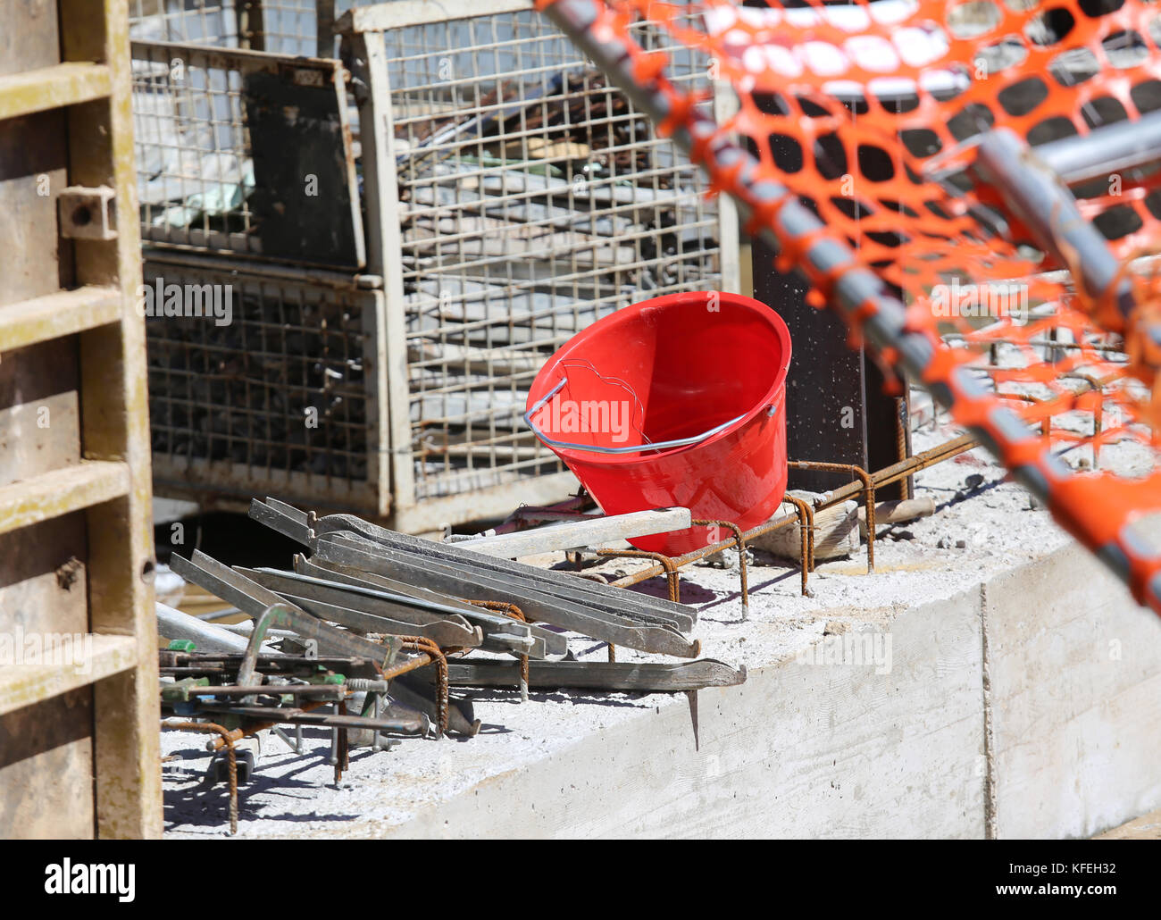 big red plastic bucket in the construction site during the masonry ...