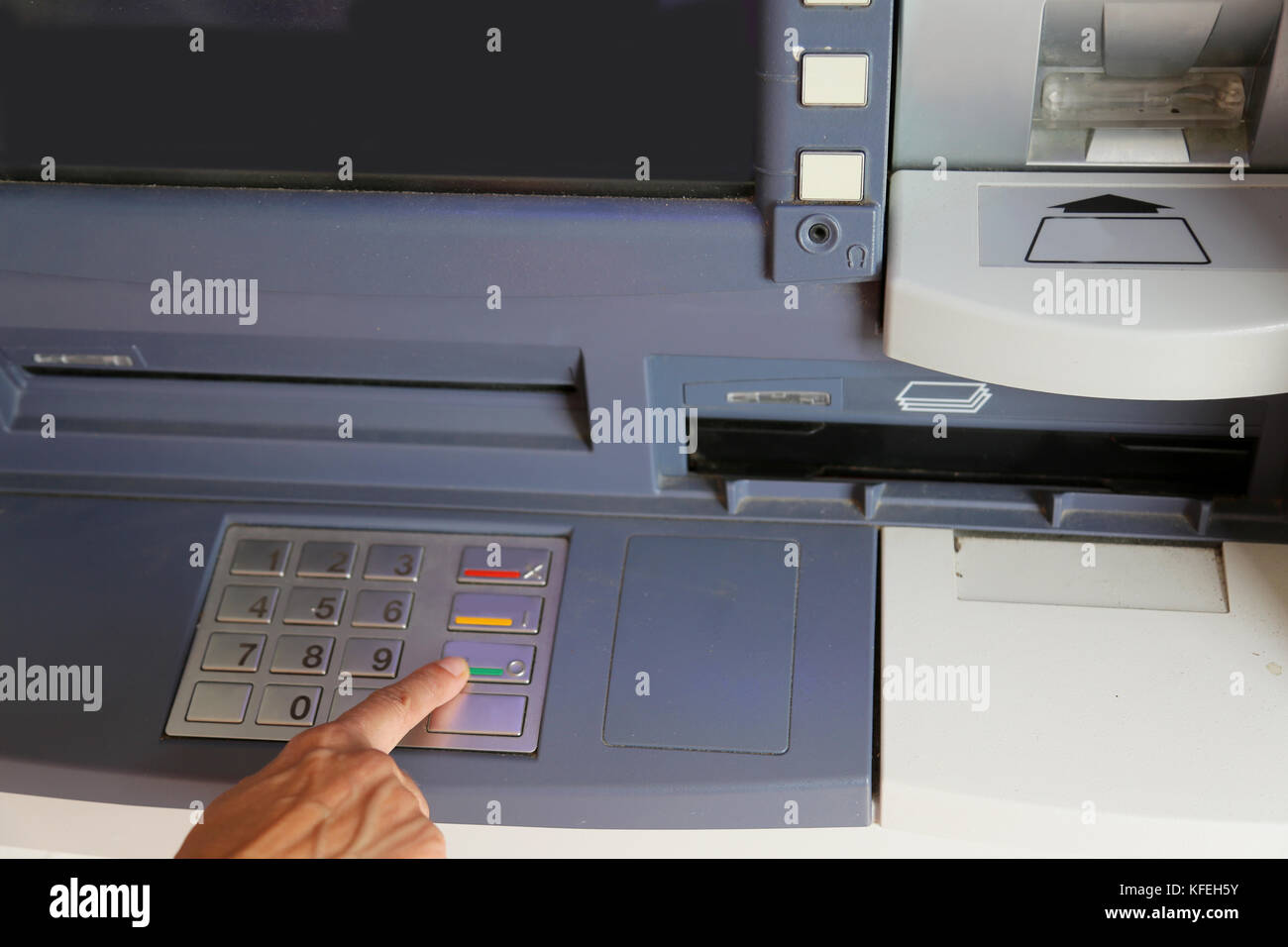 hand of woman press the buttons in the keyboard of an ATM machine to ...