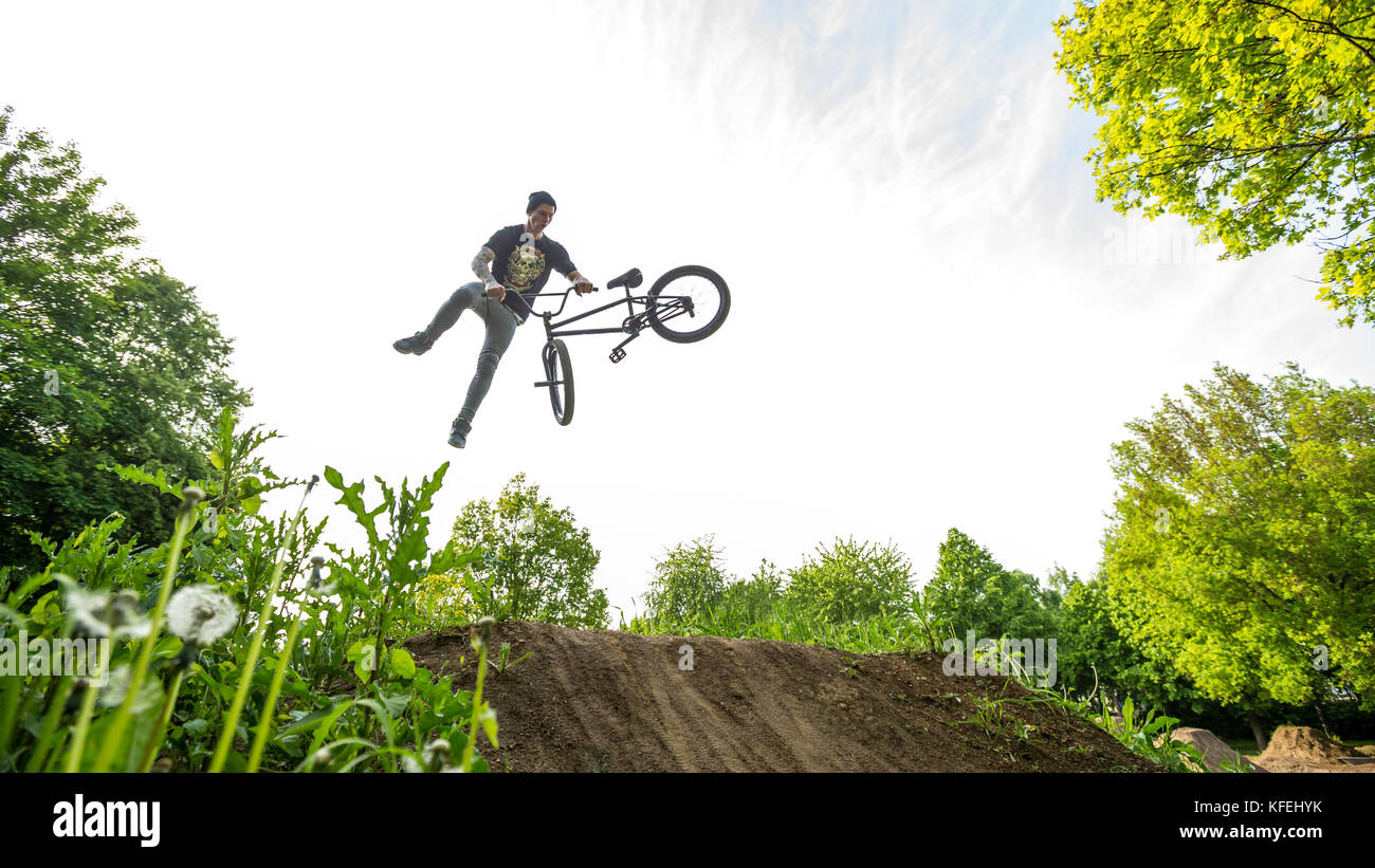 BMX driver jumping in the air Stock Photo - Alamy