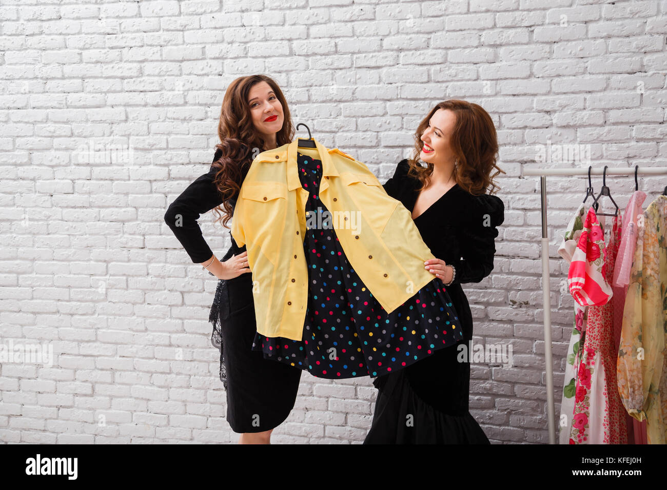Two beautiful girls choose their clothes for the evening Stock Photo ...