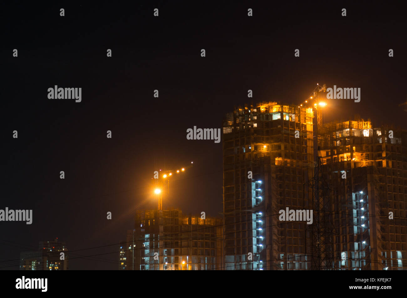 Gurgaon Noida sky scraper under construction at night Stock Photo - Alamy