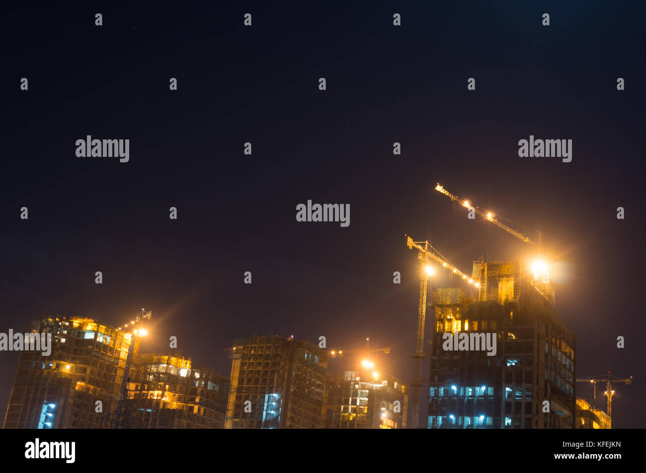 Gurgaon Noida sky scraper under construction at night Stock Photo - Alamy