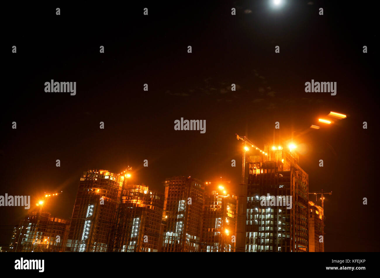 Gurgaon Noida sky scraper under construction at night Stock Photo - Alamy