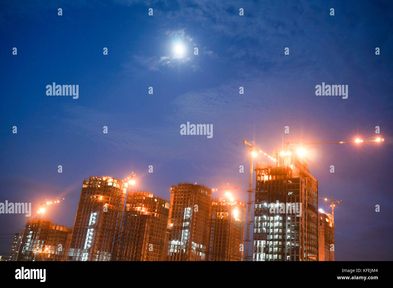 Gurgaon Noida sky scraper under construction at night Stock Photo - Alamy
