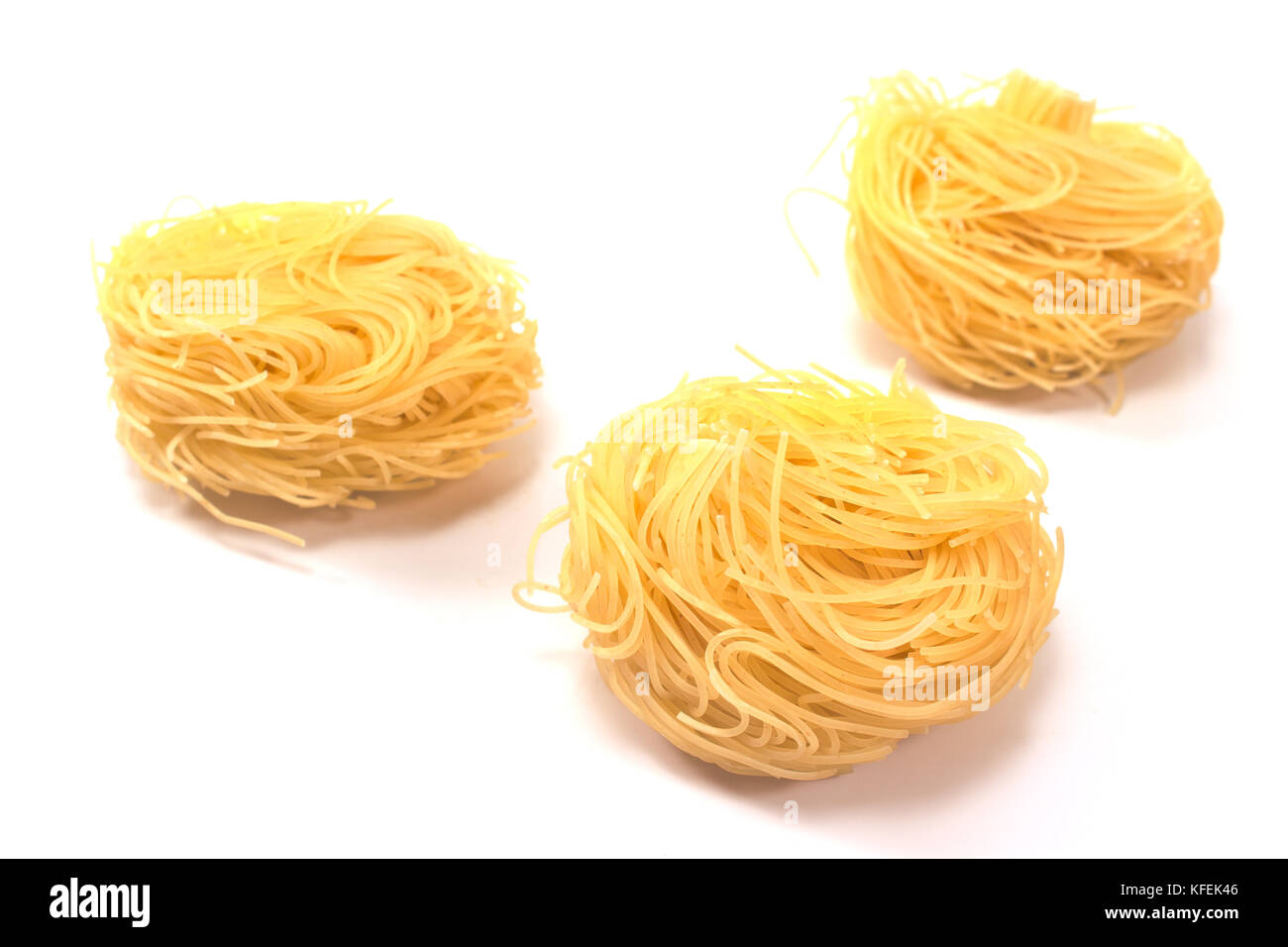 Vermicelli pasta nests isolated on white Stock Photo - Alamy