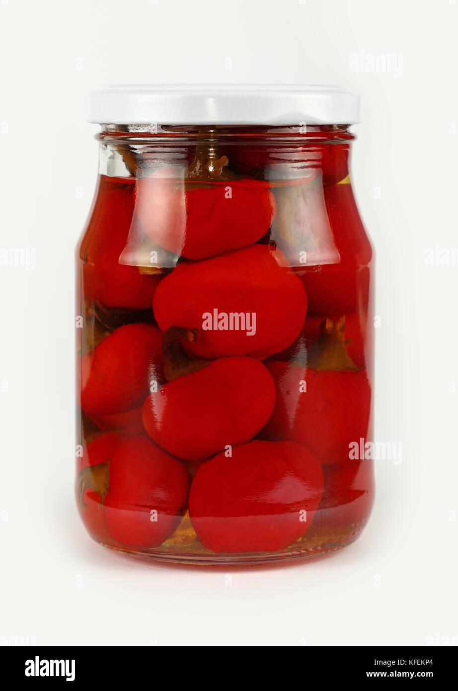 Close up of one glass jar of pickled small round red hot cherry chili ...