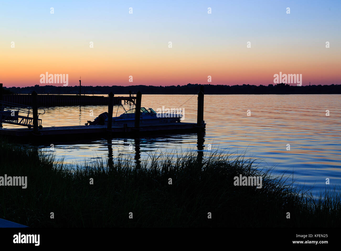 New Jersey inlet with view of the bay, dock, boat and city with boat ...