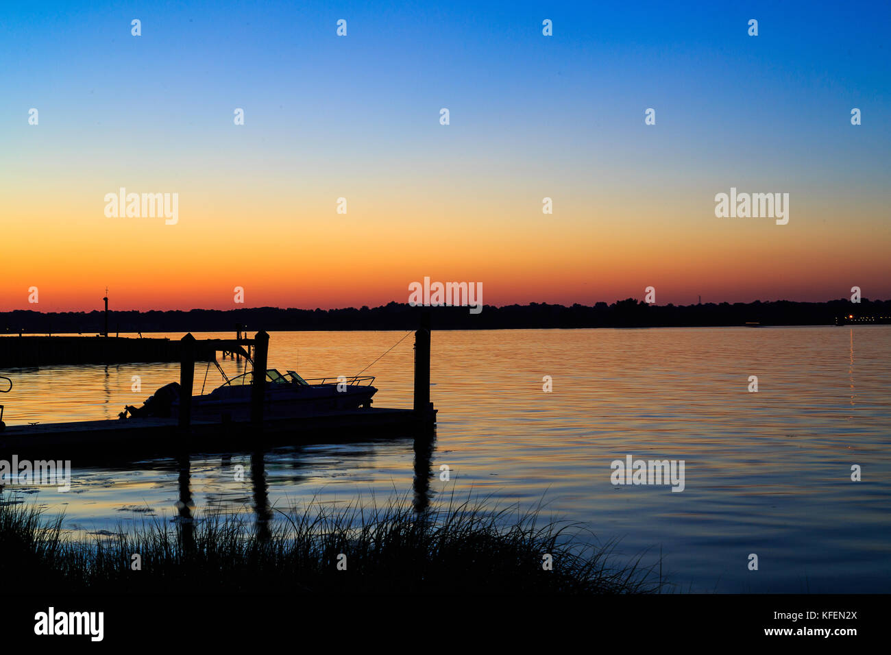New Jersey inlet with view of the bay, dock, boat and city with boat ...