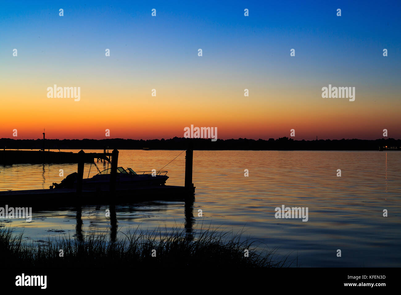 New Jersey inlet with view of the bay, dock, boat and city with boat ...