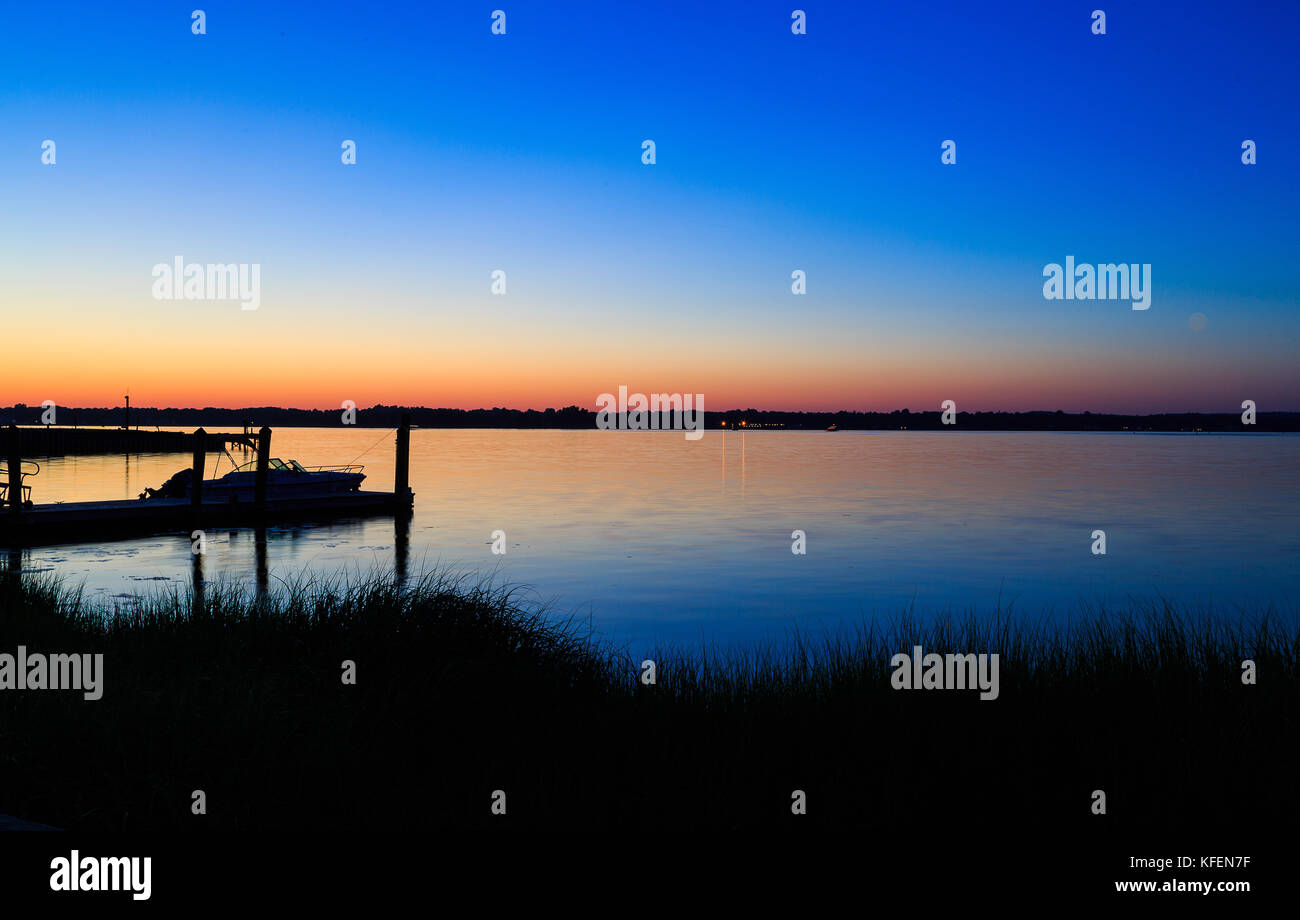 New Jersey inlet with view of the bay, dock, boat and city with boat ...