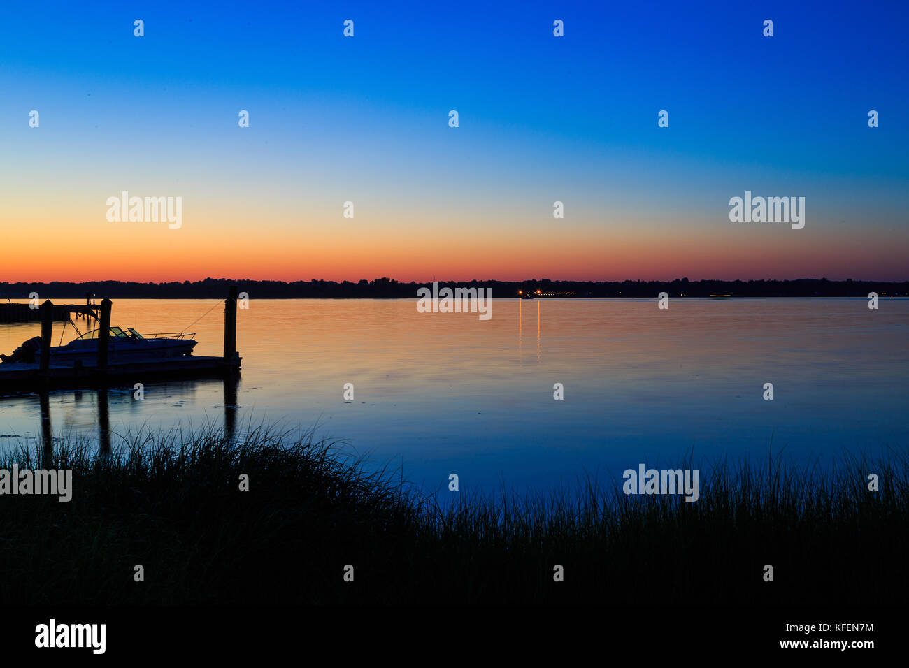 New Jersey inlet with view of the bay, dock, boat and city with boat ...