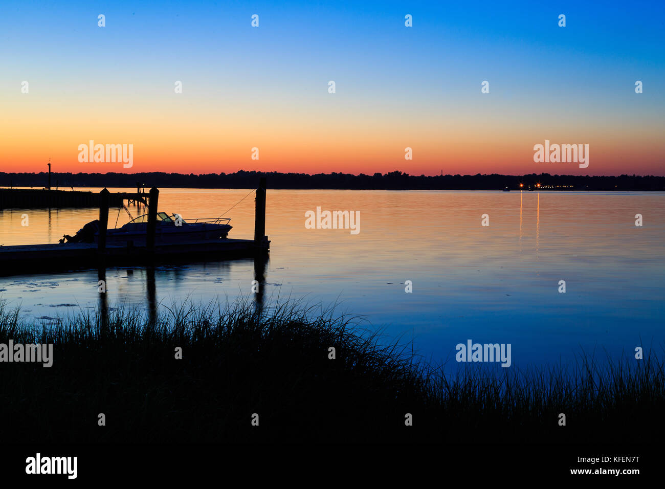 New Jersey inlet with view of the bay, dock, boat and city with boat ...
