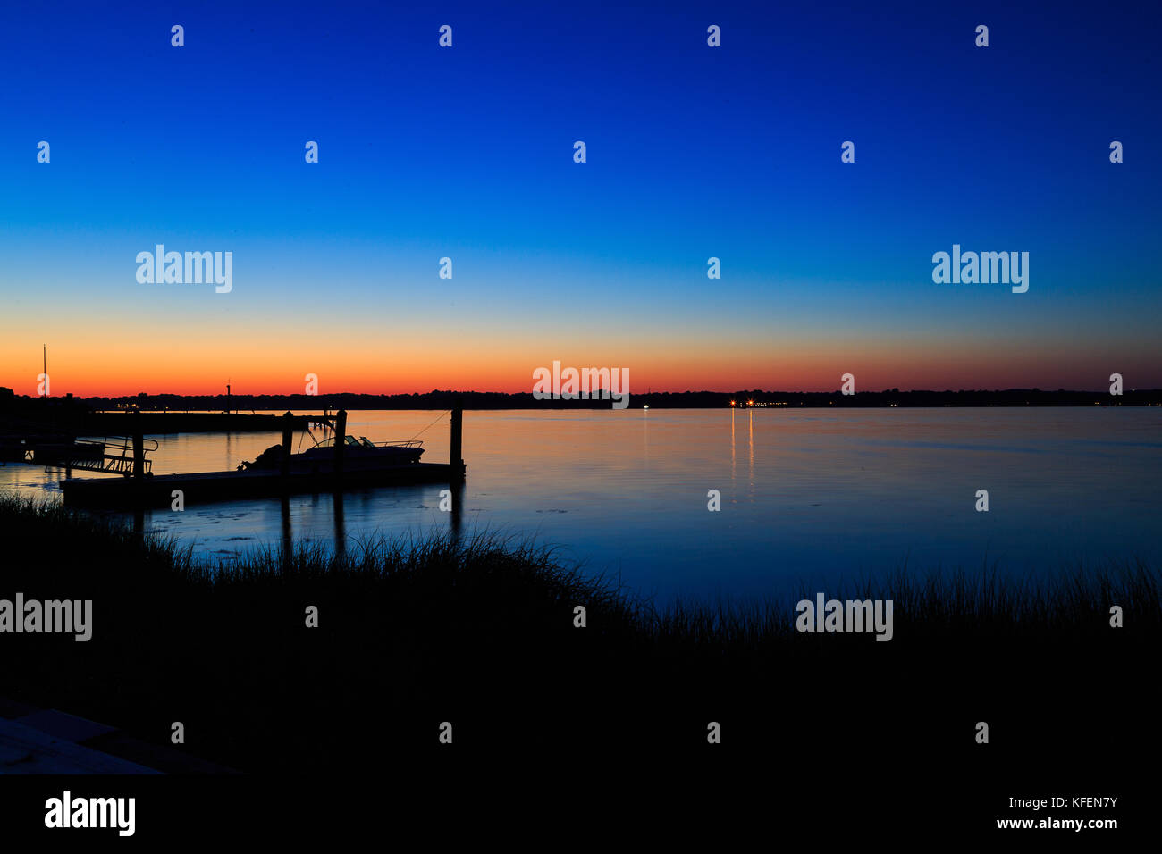New Jersey inlet with view of the bay, dock, boat and city with boat ...