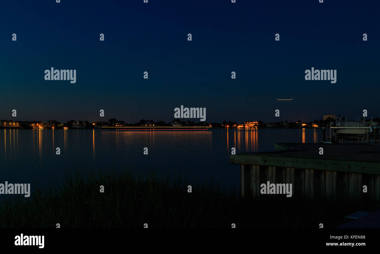 New Jersey inlet with view of the bay, dock, boat and city with boat ...