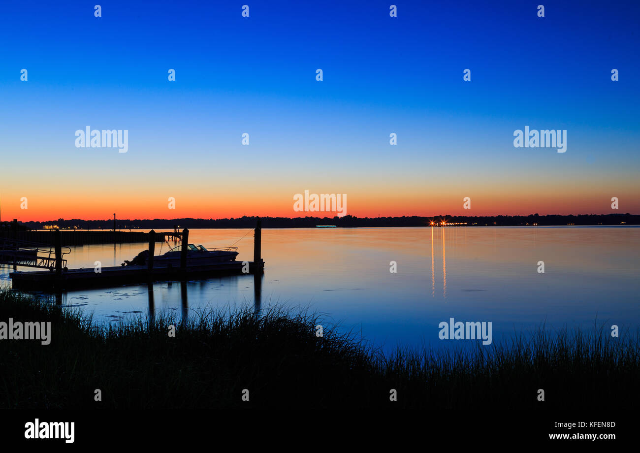 New Jersey inlet with view of the bay, dock, boat and city with boat ...