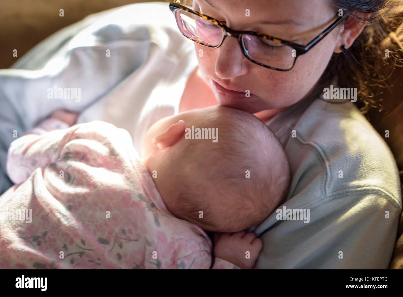 new mom napping with baby in her arms Stock Photo - Alamy