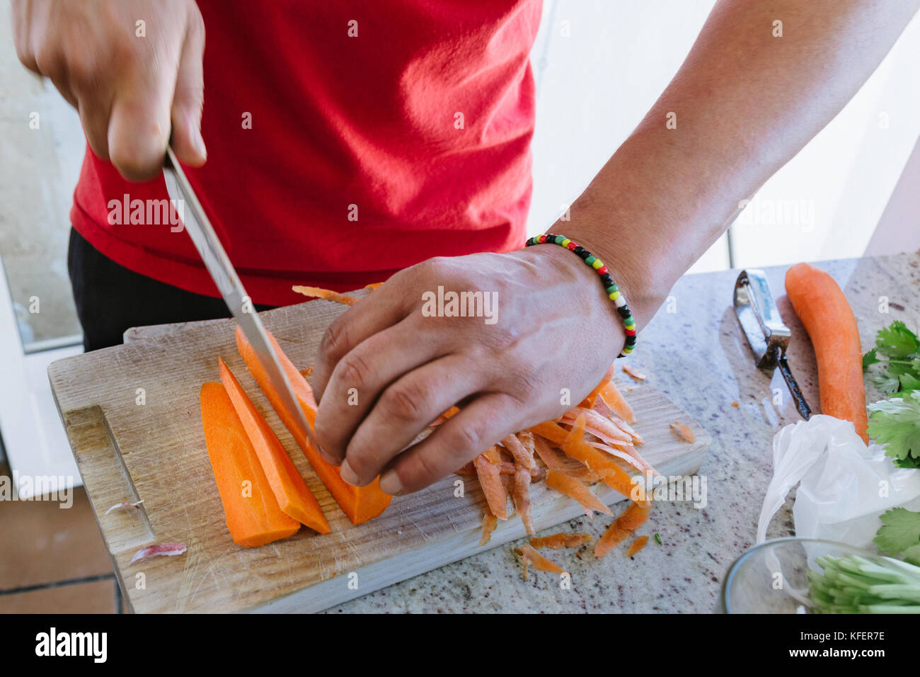 man's hands, cut carrot julienne style, in the kitchen Stock Photo - Alamy