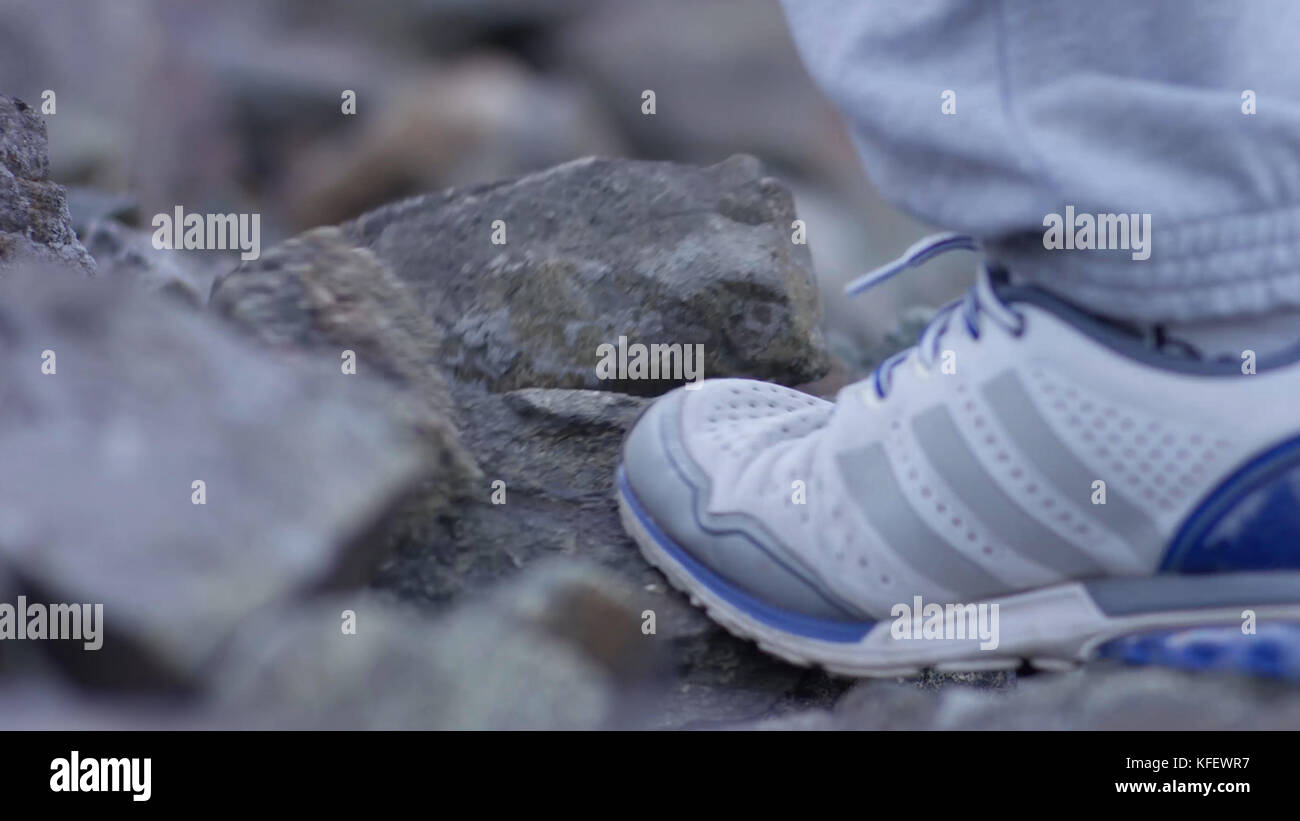 Athlete runner runs rocks in mountain. closeup of sneakers. Marathon ...