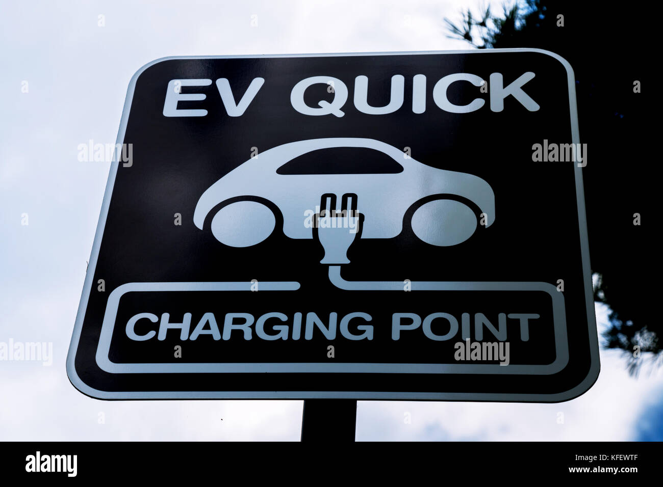 Electric vehicle (EV) quick charging point sign pole at the charging ...