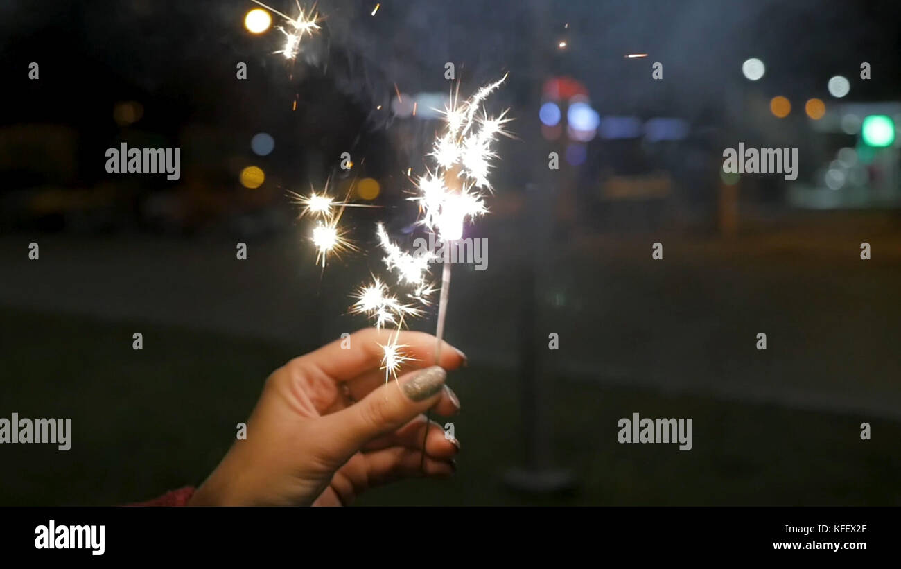 Sparkler burning sparks in hand hi-res stock photography and images - Alamy