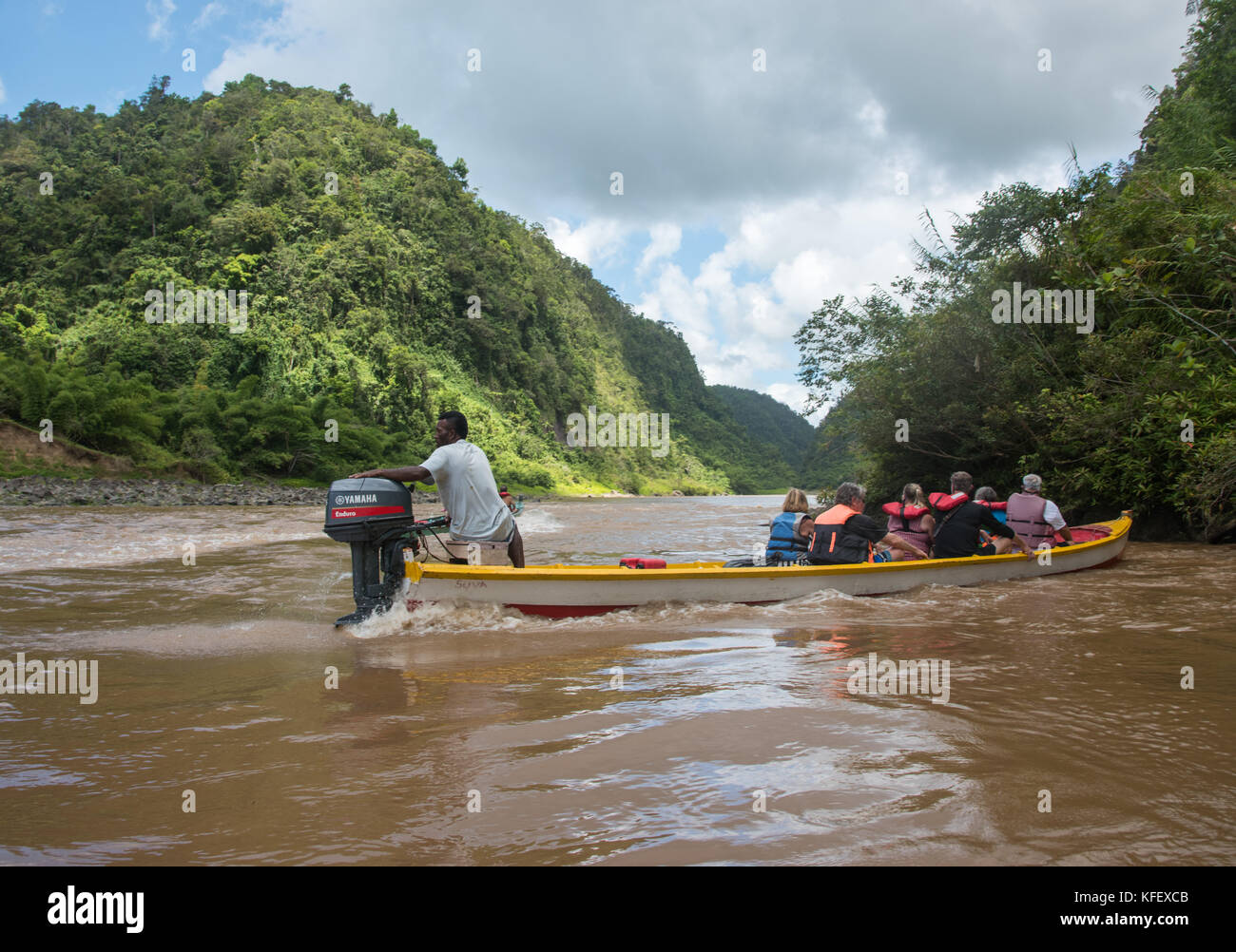 SUVA,VITI LEVU,FIJI-NOVEMBER 28,2016: Motorised longboat with tourists ...