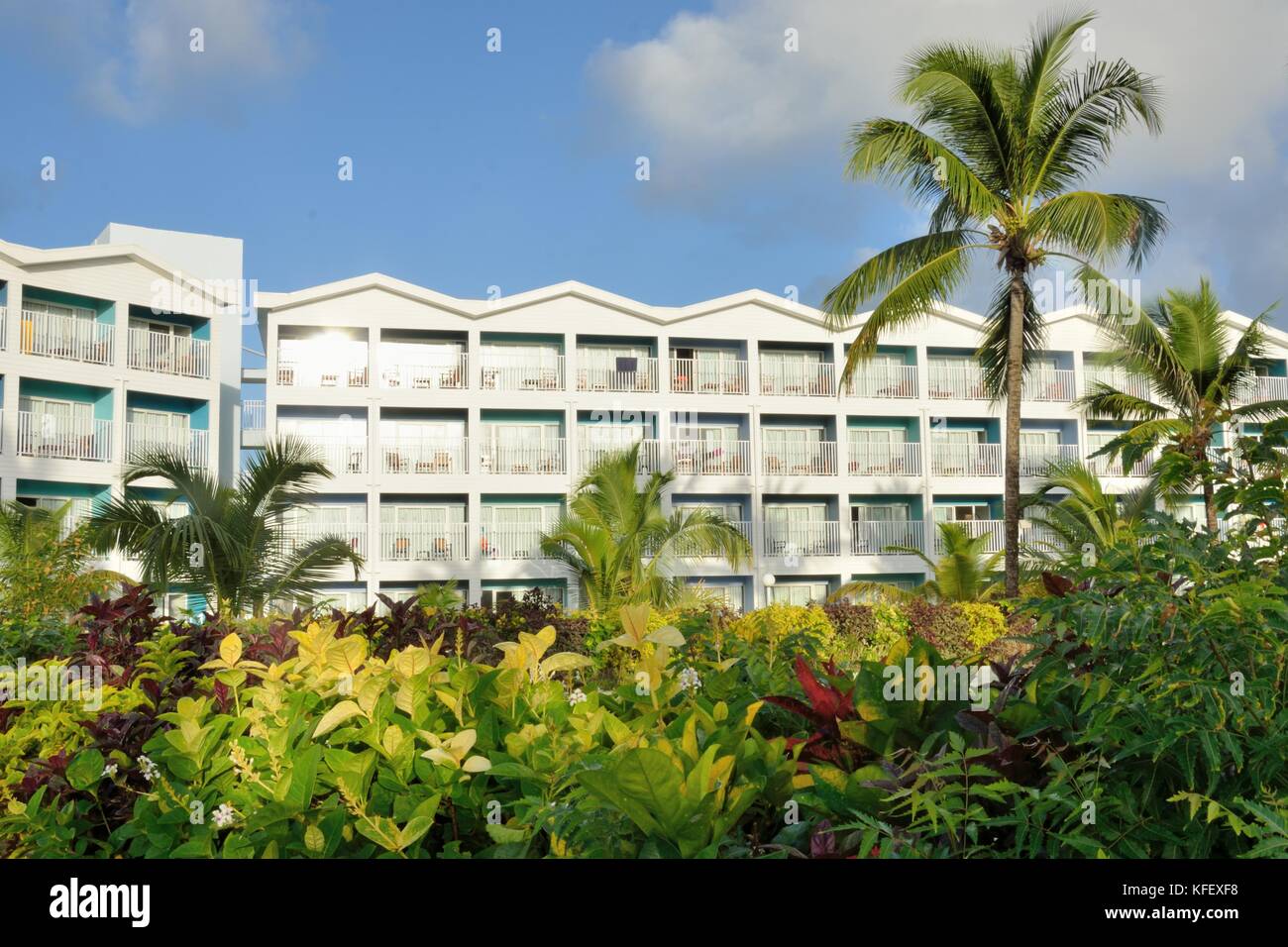 Caribbean hotel with greenery in foreground Stock Photo - Alamy